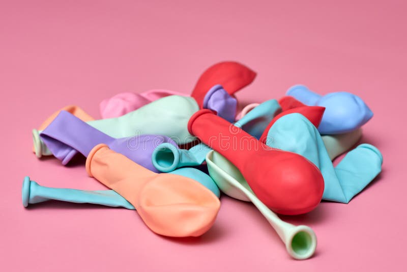 Multicolored Not Inflated Balloons on a Pink Background Stock Photo ...