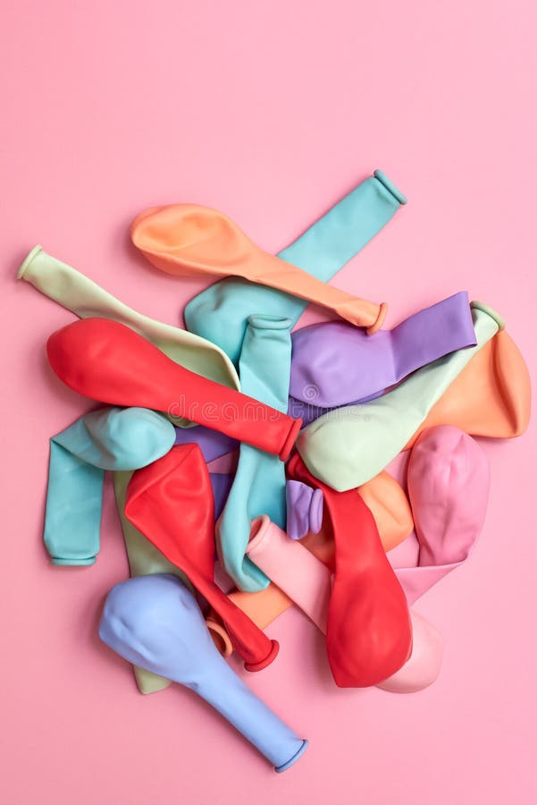 Multicolored Not Inflated Balloons on a Pink Background Stock Photo ...