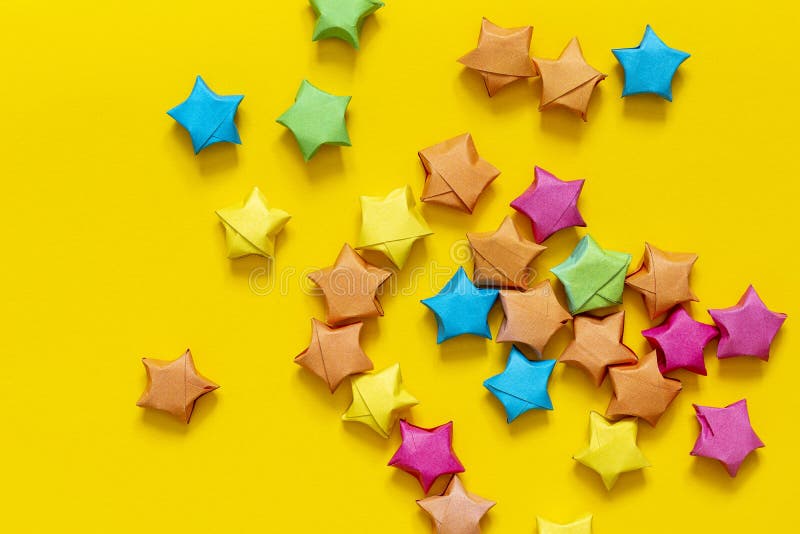Multicolored Origami Paper Star on Yellow Backdround. Top View Stock ...