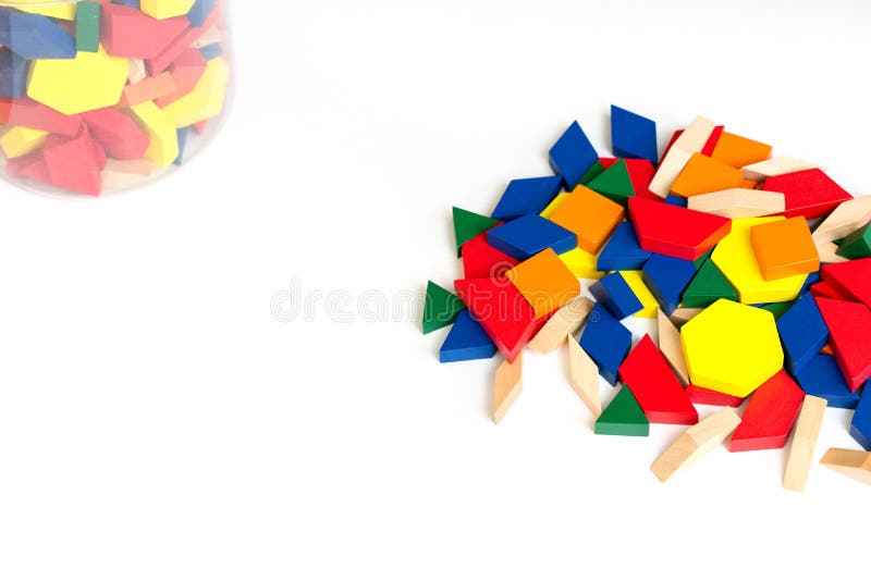 Multicolored Pattern Blocks on a White Wooden Background.Box with ...