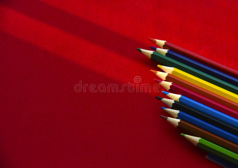 Multicolored Pencils on a Red Background in the Light Stock Image ...