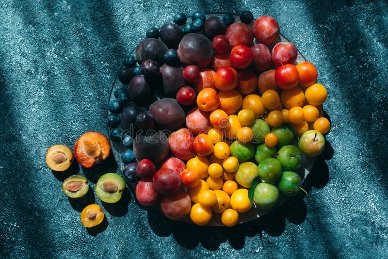 Multicolored Plums on a Plate are Laid Out by Color. Stock Photo ...