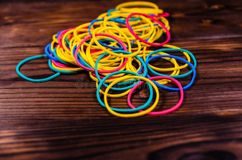 Multicolored Rubber Bands on Wooden Table Stock Image - Image of pile ...
