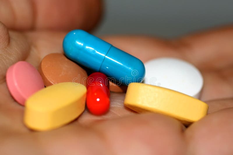 Multicolored Tablets and Capsules in the Palm of Your Hand Stock Image ...