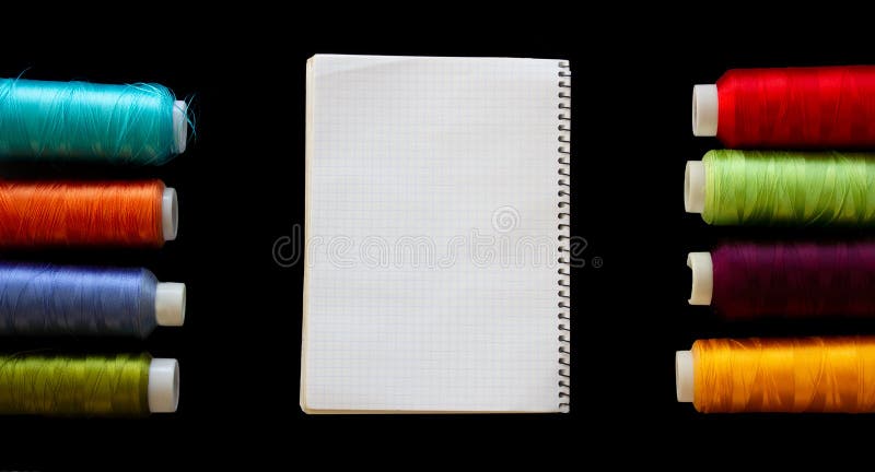 Multicolored Threads and Notebook for Notes on a Black Background. View ... Multicolored Threads and Notebook for Notes on a Black Background. View ...