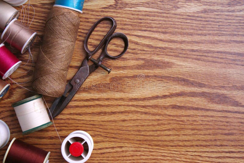 Multicolored Threads and Old Scissors Scattered on a Wooden Table ...