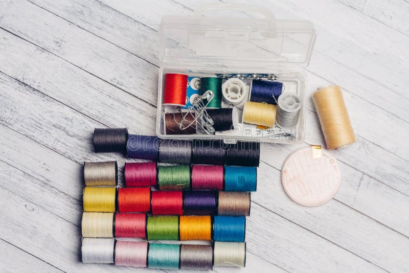 Multicolored Threads and Other Sewing Accessories on the Table Needles ...
