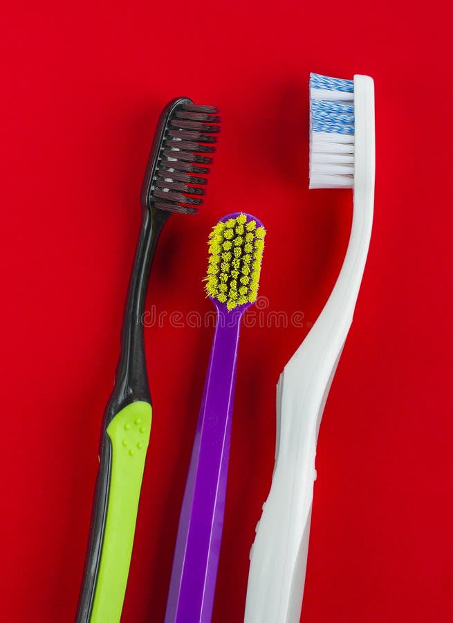 Multicolored Toothbrushes on a Red Background Stock Photo - Image of ...