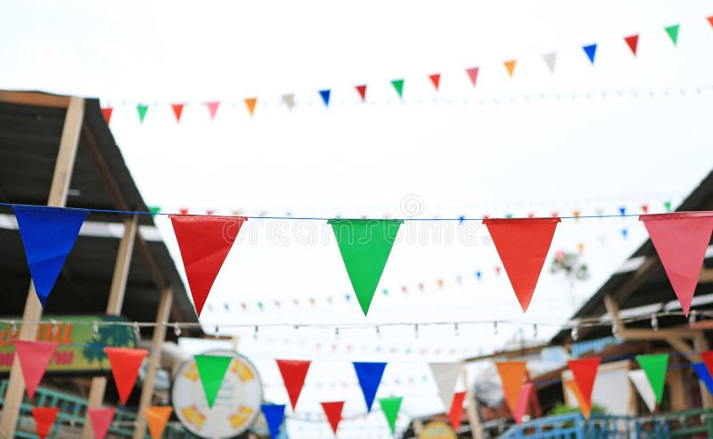 Multicolored Triangular Flags Hanging between Old Vintage House Stock ...