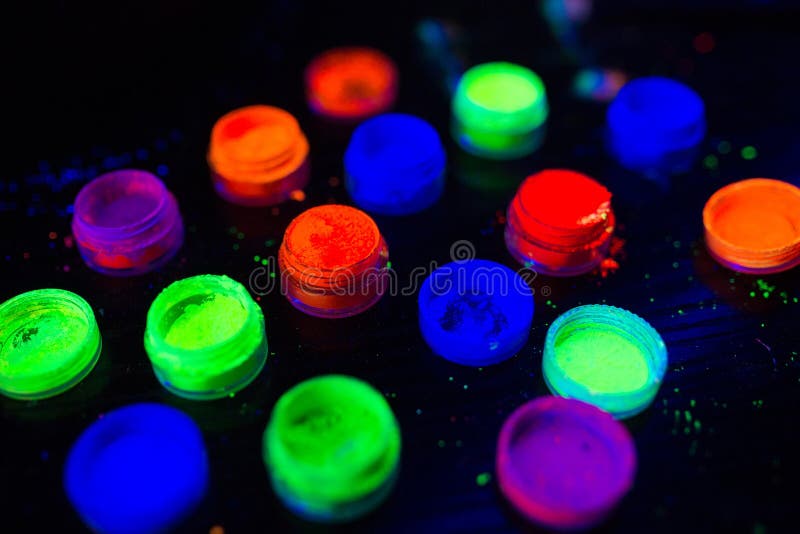 Multicolored UV Powder in Containers on the Black Background. Stock ...