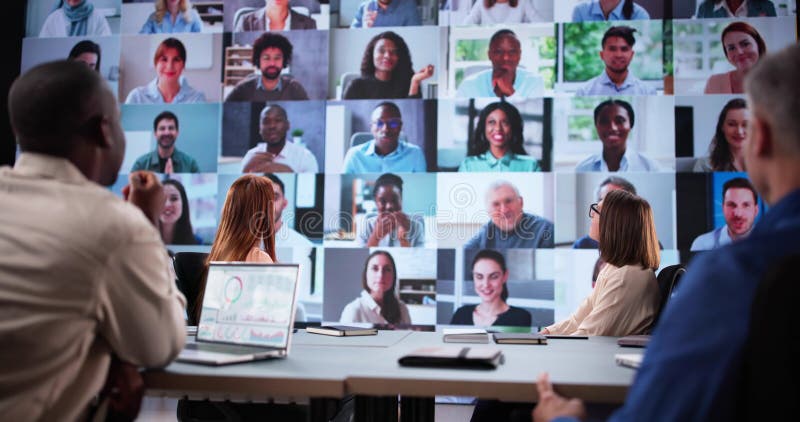 Multicultural Business Associates Discussing Project in Office Space ...