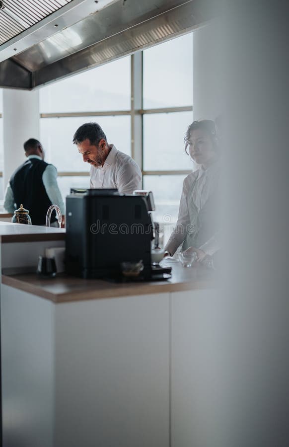 Multicultural Business Workers in a Modern Kitchen Setting Preparing ...