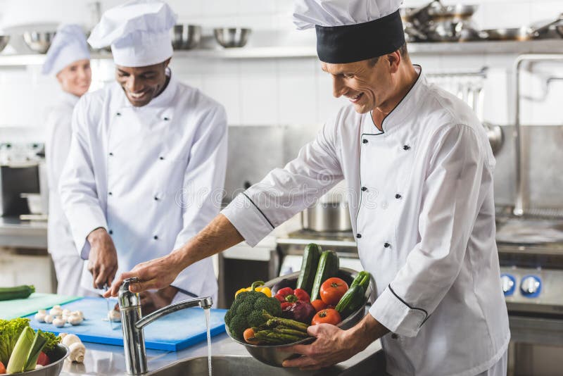 Multicultural Chefs Cutting and Washing Vegetables Stock Photo - Image ...
