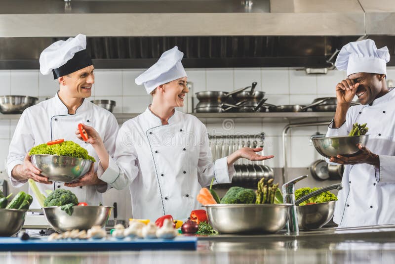 Two chefs laughing at work stock photo. Image of sweet - 162599594