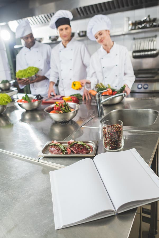 Multicultural Chefs at Restaurant Kitchen with Recipe Book Stock Photo ...