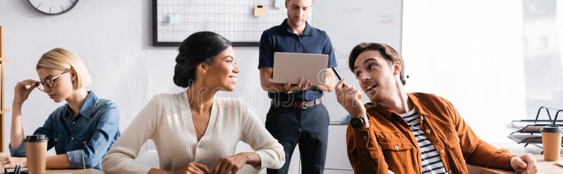 Multicultural Co-workers Talking while Sitting Stock Photo - Image of ...