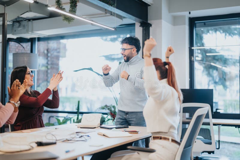 Multicultural Colleagues Celebrating Successful Completion of Project ...