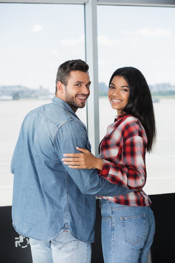 Multicultural Couple Smiling while Hugging in Stock Image - Image of ...