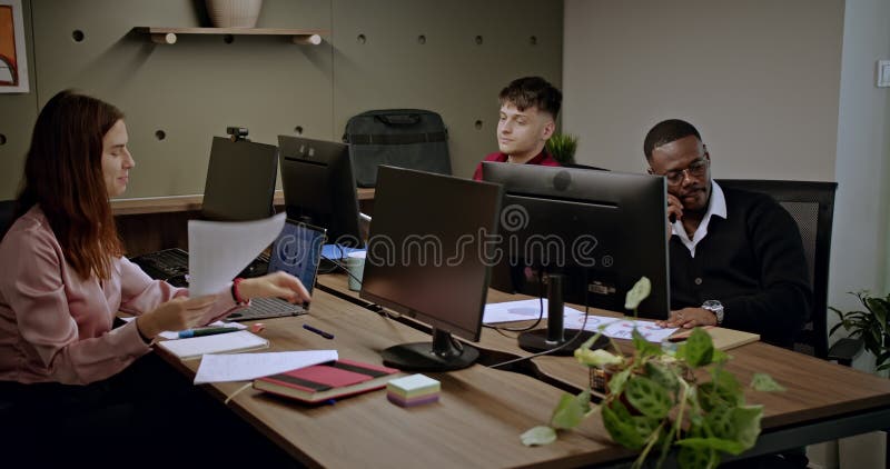 Multicultural Employees Analyzing Project Paperwork and Company Growth ...