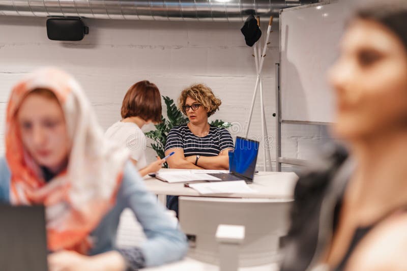 Multicultural Employees Working in Groups at Modern Classroom. Learning ...