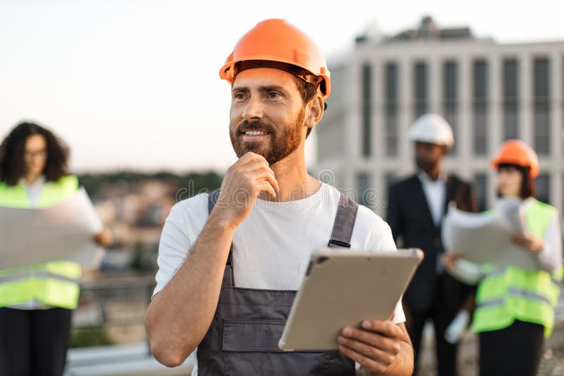 Multicultural Engineers Meeting on Roof of Construction Site Stock ...