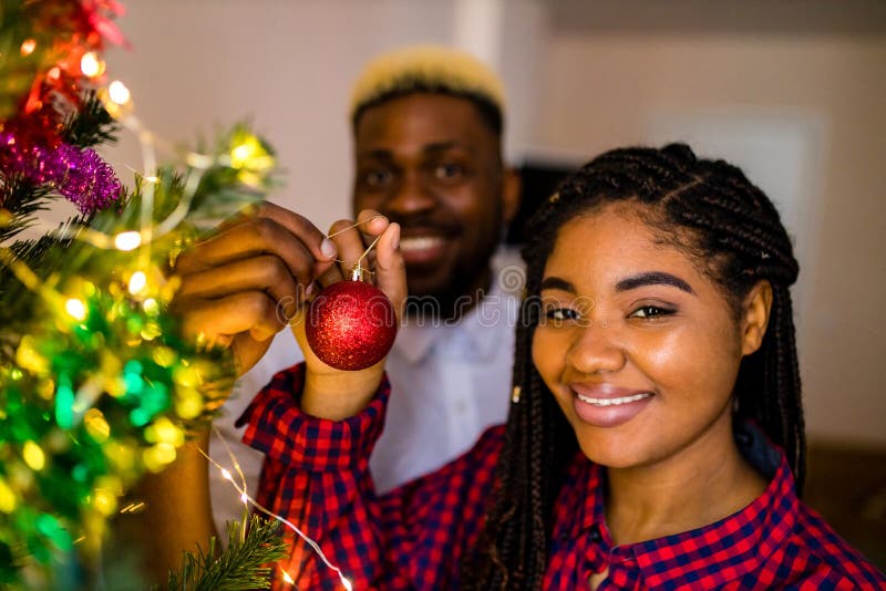 Multicultural Family Decorating Christmas Tree with Ball and Garland ...
