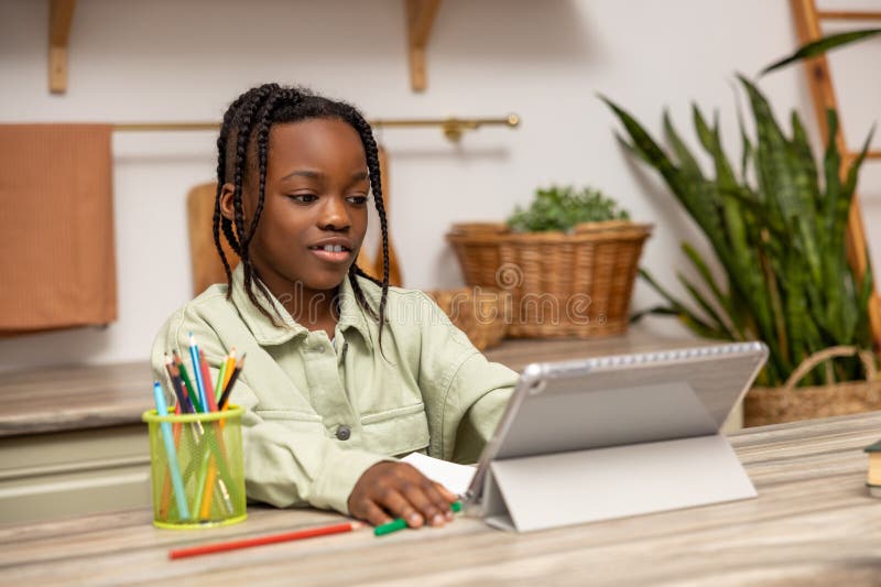 Multicultural Female Child Sitting at Table Working on Her Homework ...