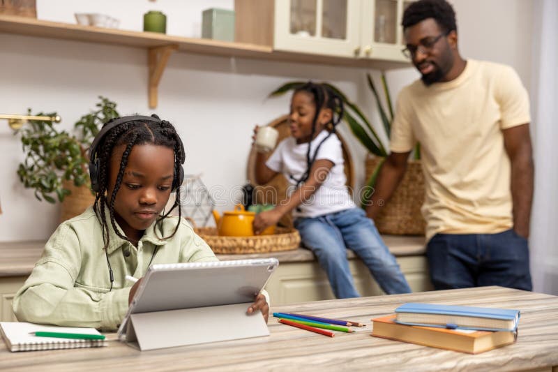 Multicultural Female Child Sitting at Table Working on Her Homework ...