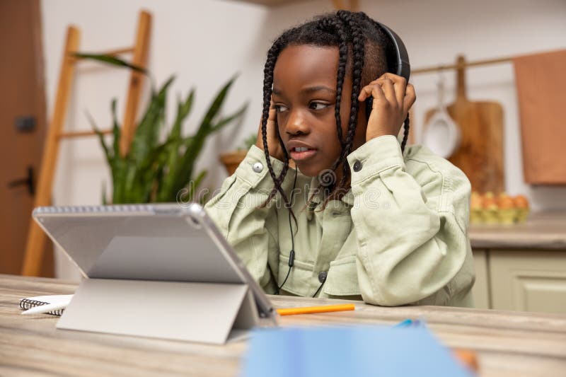 Multicultural Female Child Sitting at Table Working on Her Homework ...