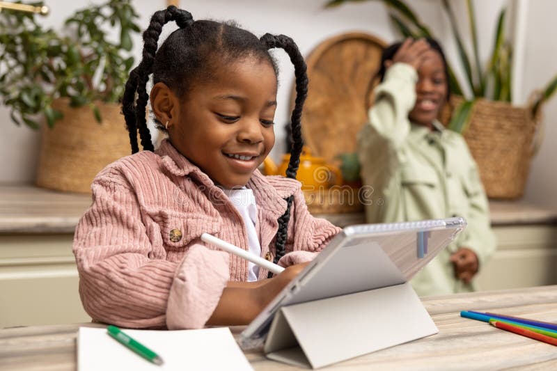 Multicultural Female Child Sitting at Table Working on Her Homework ...