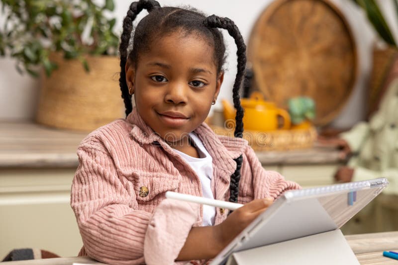 Multicultural Female Child Sitting at Table Working on Her Homework ...