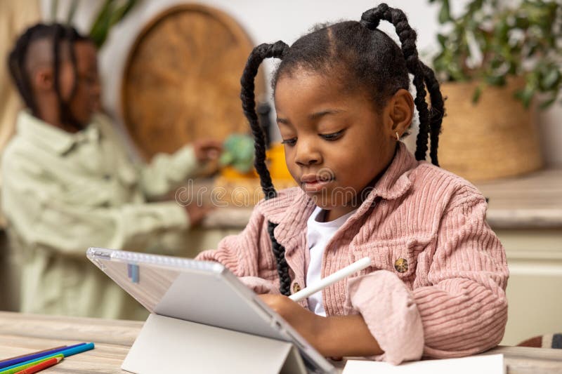 Multicultural Female Child Sitting at Table Working on Her Homework ...