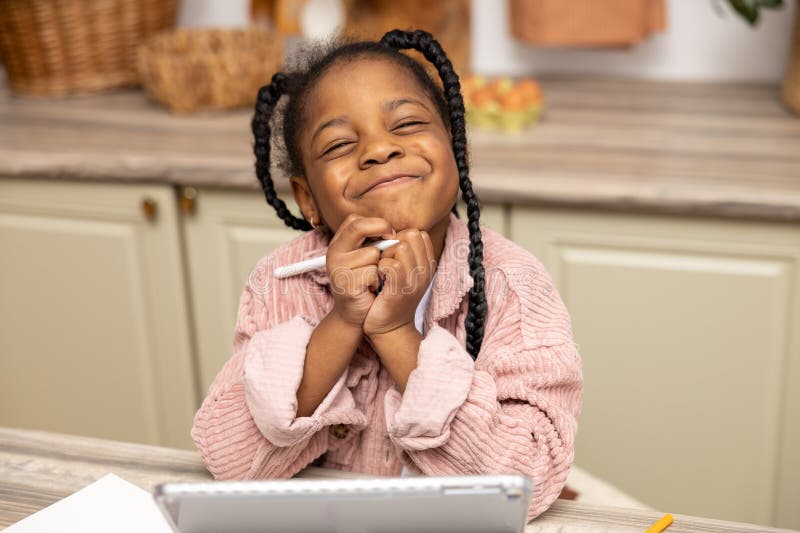 Multicultural Female Child Sitting at Table Working on Her Homework ...