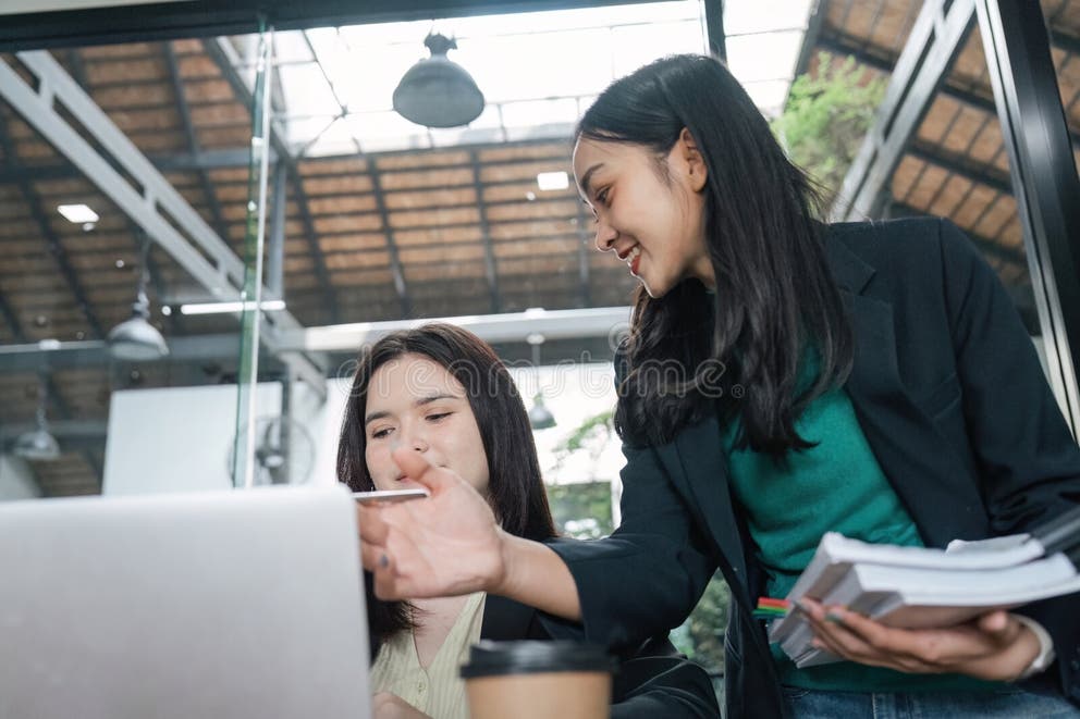 Multicultural Female Professionals Discussing Strategies and Analyzing ...