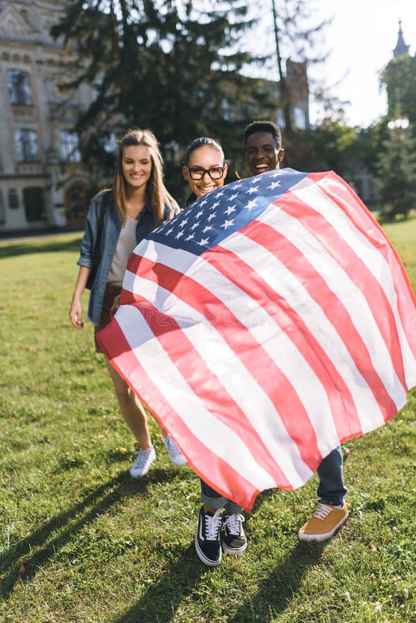Multicultural Group of Friends Holding American Flag Stock Image ...