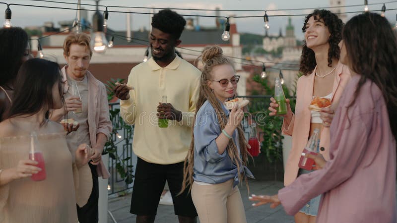 Multicultural Friends Dancing, Drinking and Eating on Party Stock ...