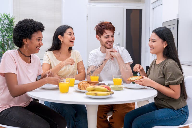 Multicultural Friends Enjoying Breakfast in a Bright Kitchen Stock ...
