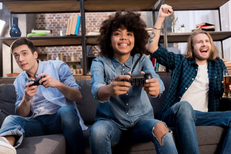 Multicultural Friends Playing Video Game on Sofa Stock Photo - Image of ...