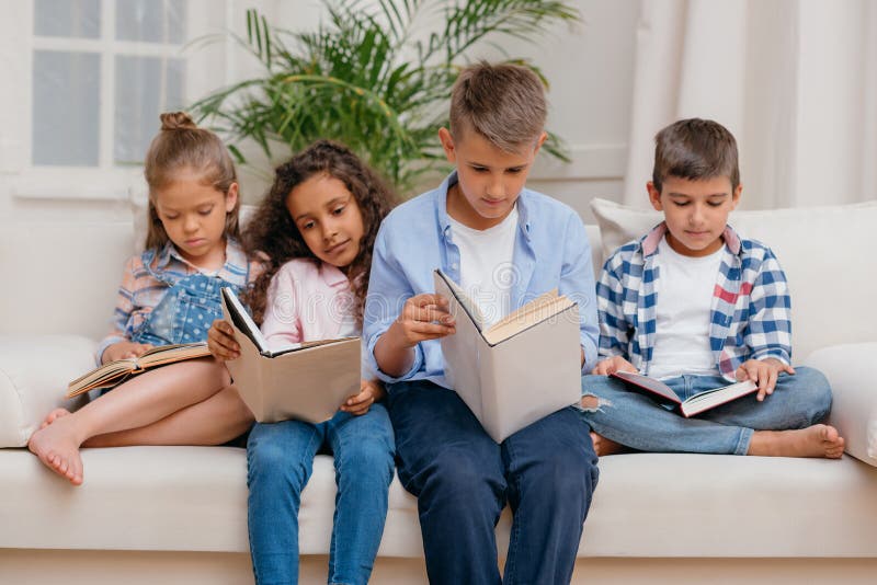 Multicultural Group of Focused Children Reading Books while Sitting on ...