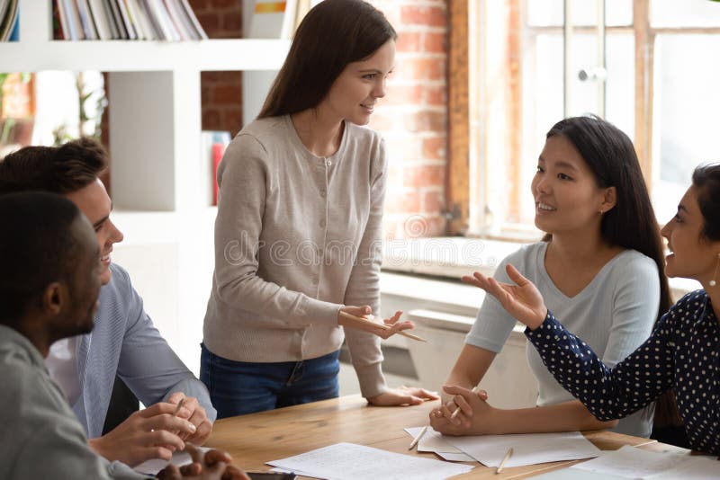 Multicultural Group Gather Discussing Project in Classroom Together ...
