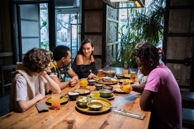 A Multicultural Group of Students in a Cafe, Eating Asian Food, Stock ...