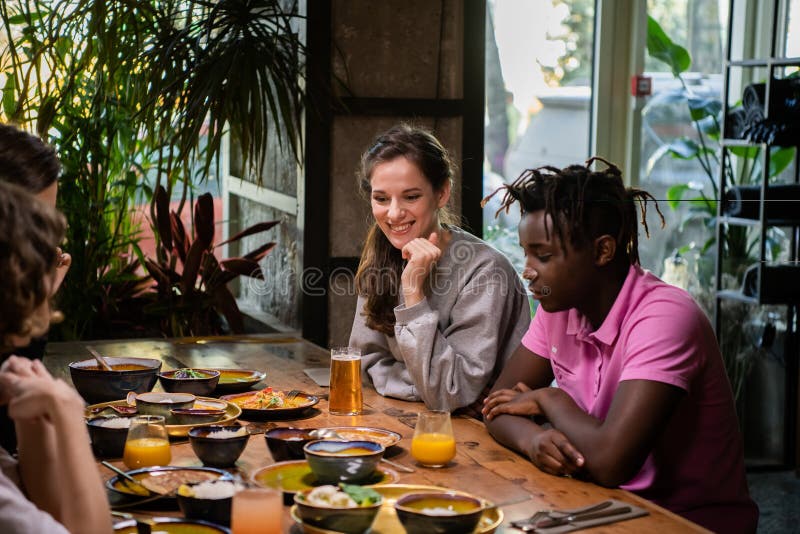 A Multicultural Group of Students in a Cafe, Eating Asian Food, Stock ...