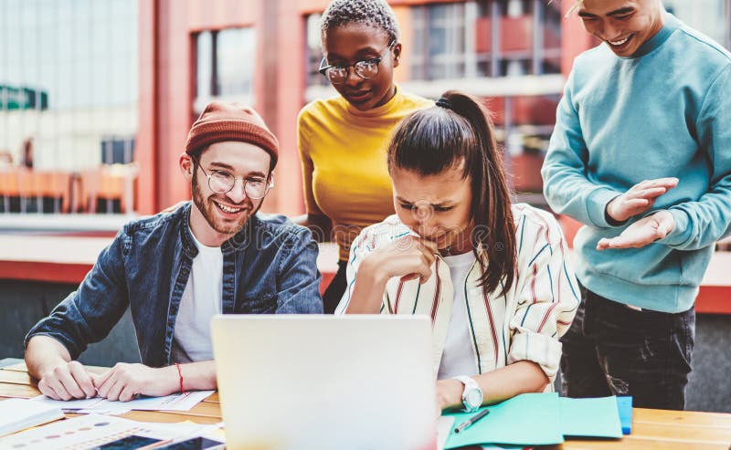 Multicultural Hipster Guys Using Wireless Internet for Team Work Stock ...