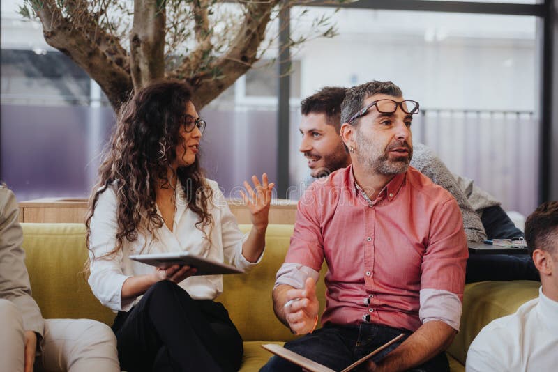 Multicultural and Inter Generational Colleagues Collaborate in a Modern ...