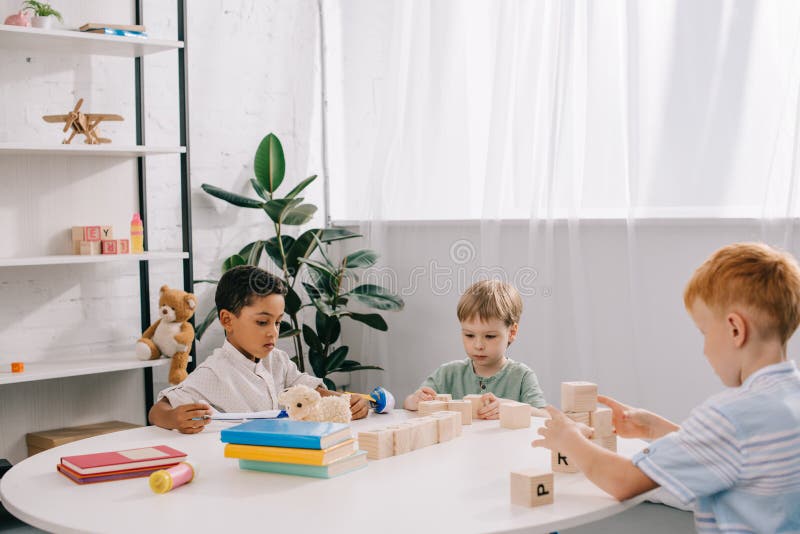 Multicultural Little Boys Plying with Wooden Blocks at Table Stock ...