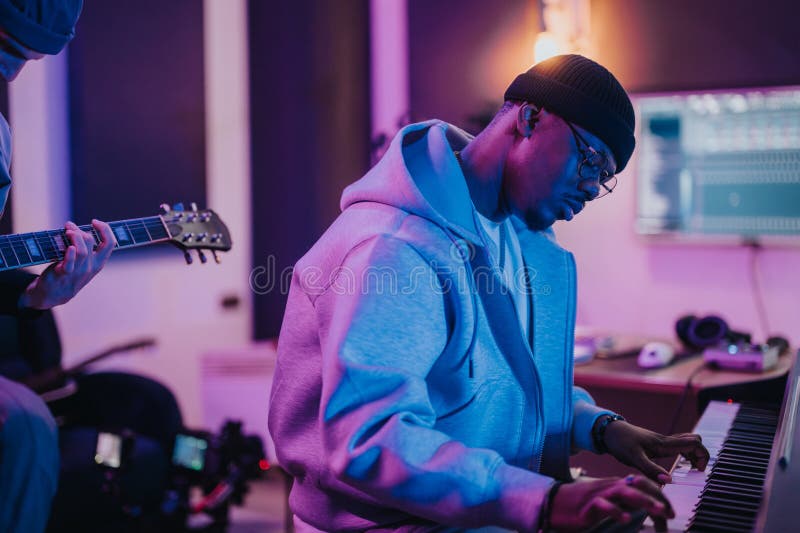 A Multicultural Musicians Working Together in a Music Studio, Using ...