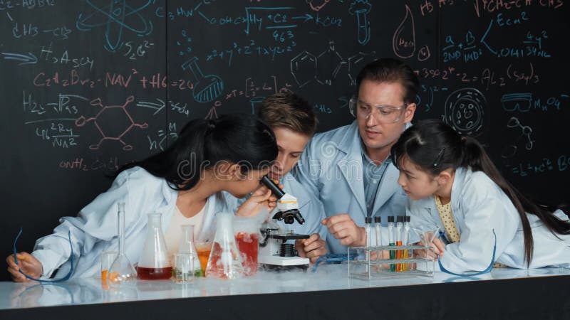 Student Looking Under Microscope while Cute Girl Inspect Sample ...