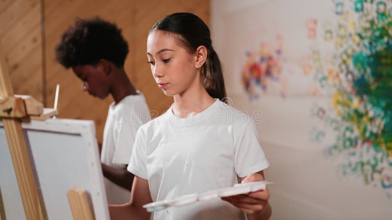 Multicultural Student Paint the Canvas Together in Art Lesson ...