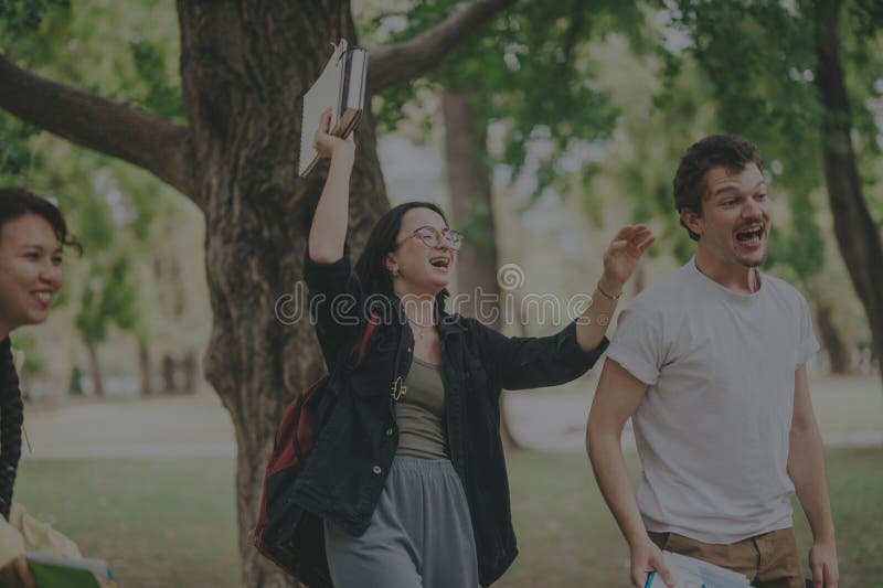 Multicultural Students Celebrating a Successful Group Study Session in ...
