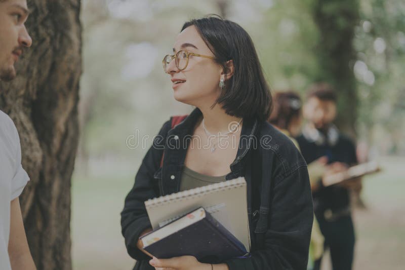 Multicultural Students Collaborating Outdoors on Academic Projects in ...